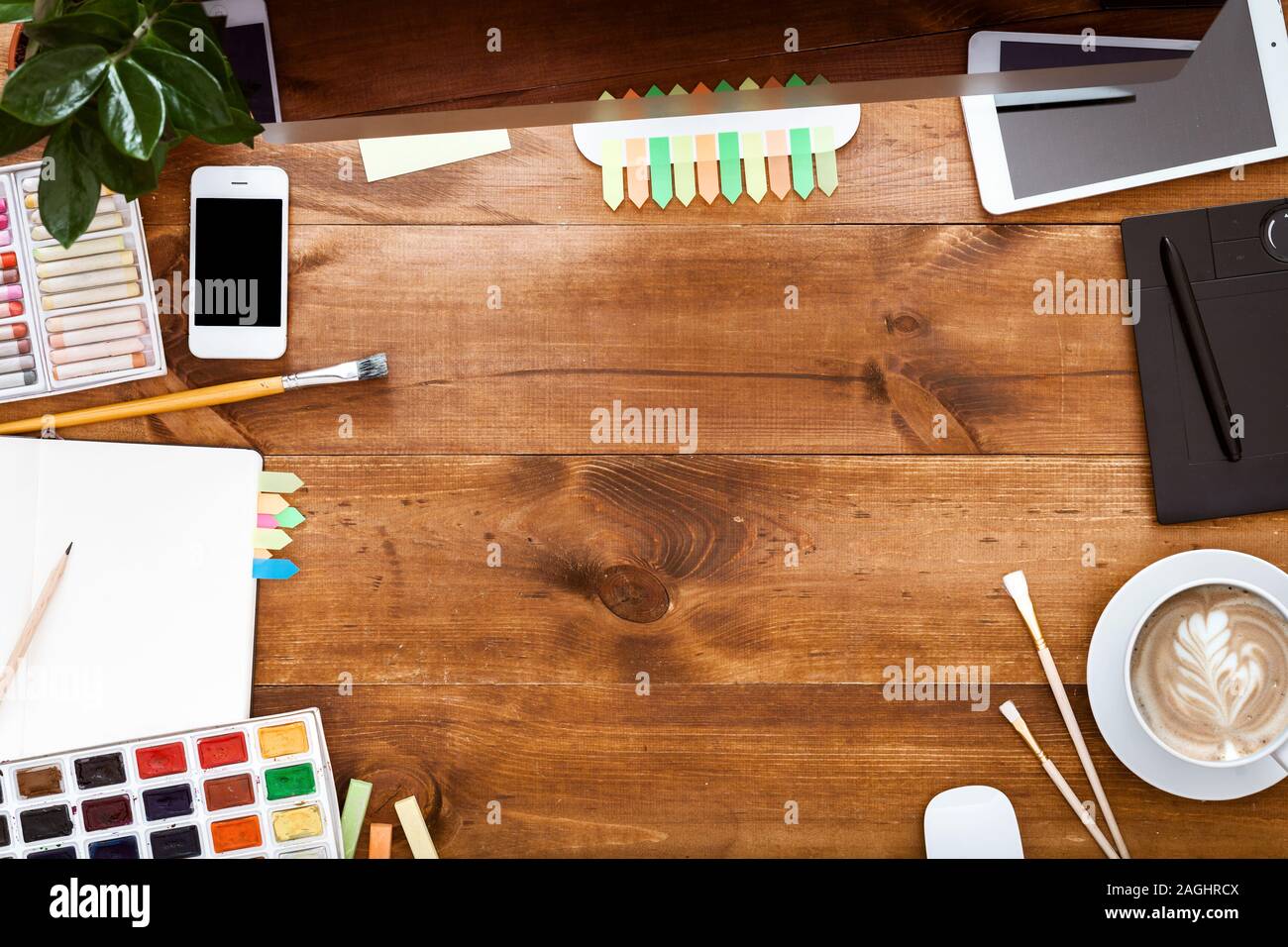 Modern creative design workplace concept, computer monitor and paints ...