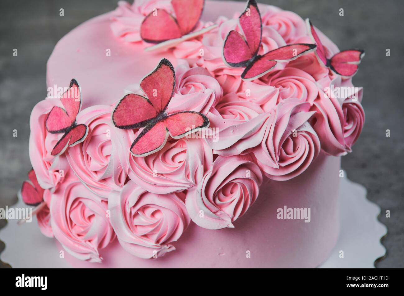 Overhead view of a freshly baked cake decorated with pink icing sugar ...