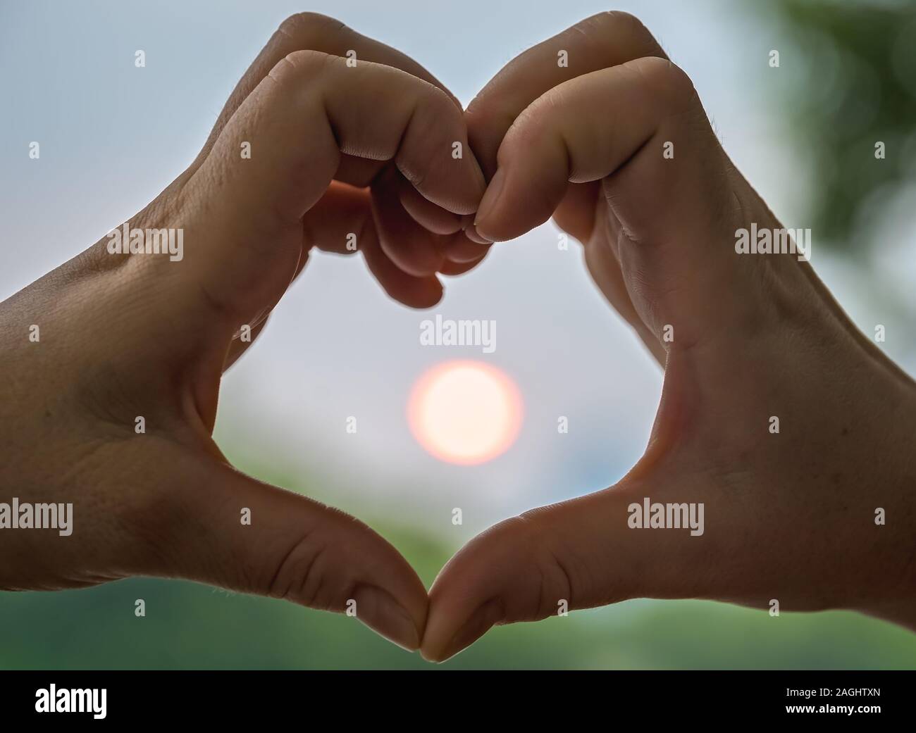 Mans hands catching sun love hi-res stock photography and images - Alamy