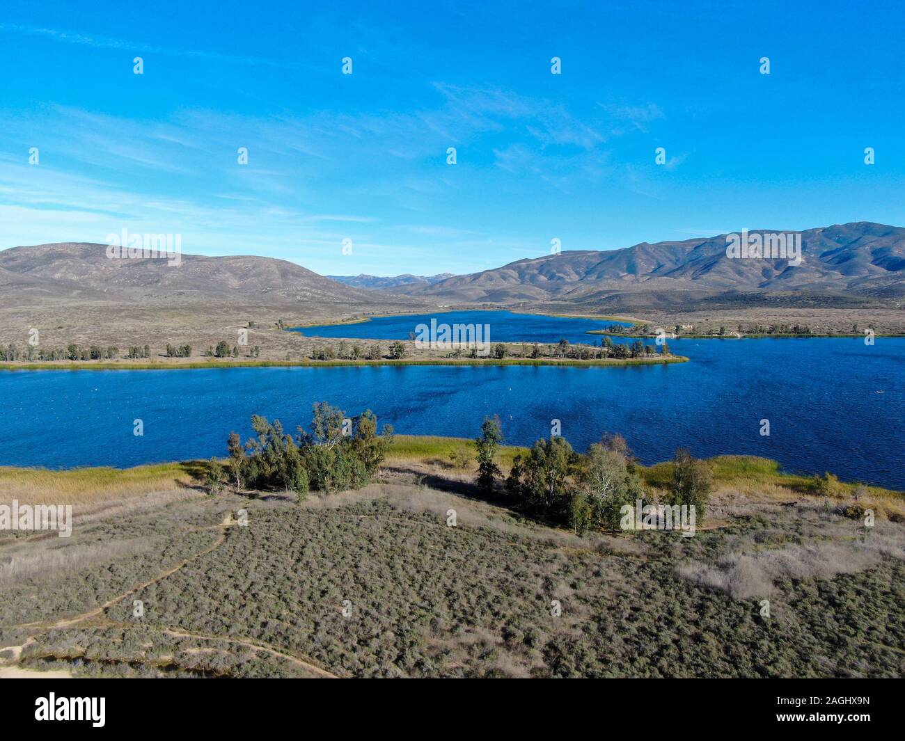 Aerial view of Otay Lake Reservoir with blue sky and mountain on the ...