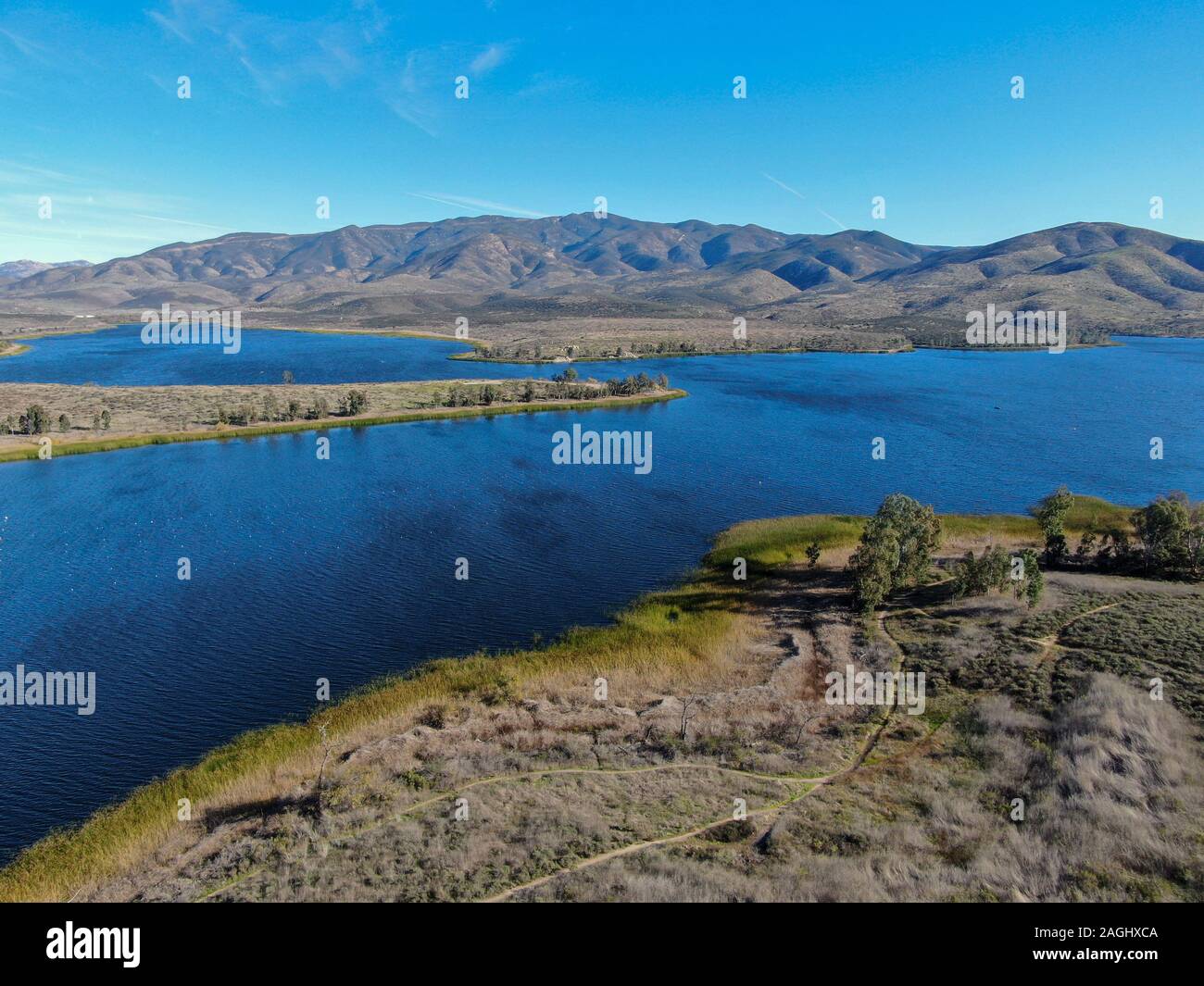 Aerial view of Otay Lake Reservoir with blue sky and mountain on the ...