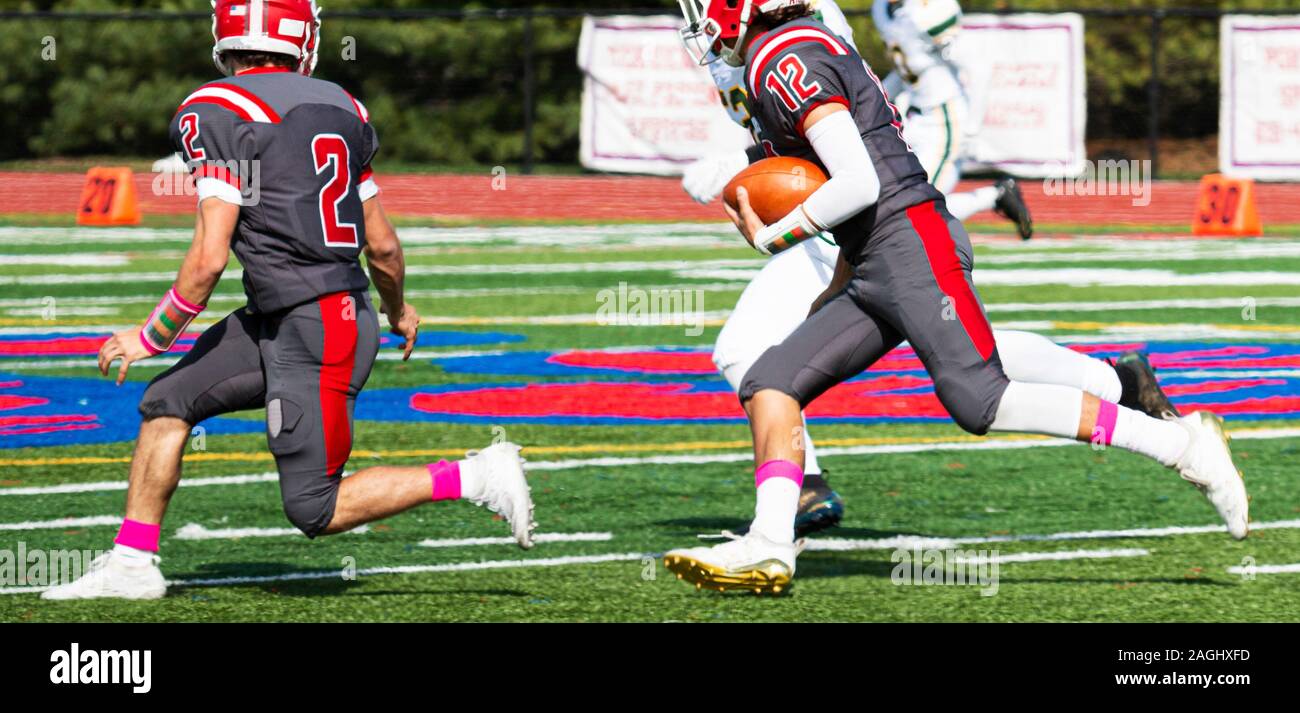 A football player avoiding getting tackled during a game by following ...