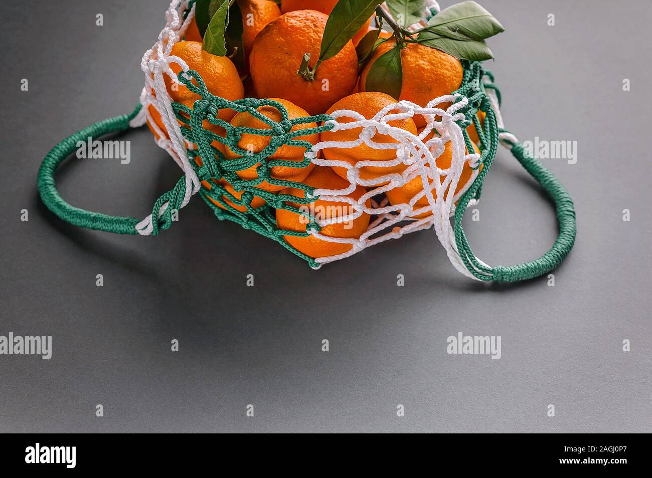 Close up tangerines in a mesh shopping bag. Zero Waste and NO plastic ...