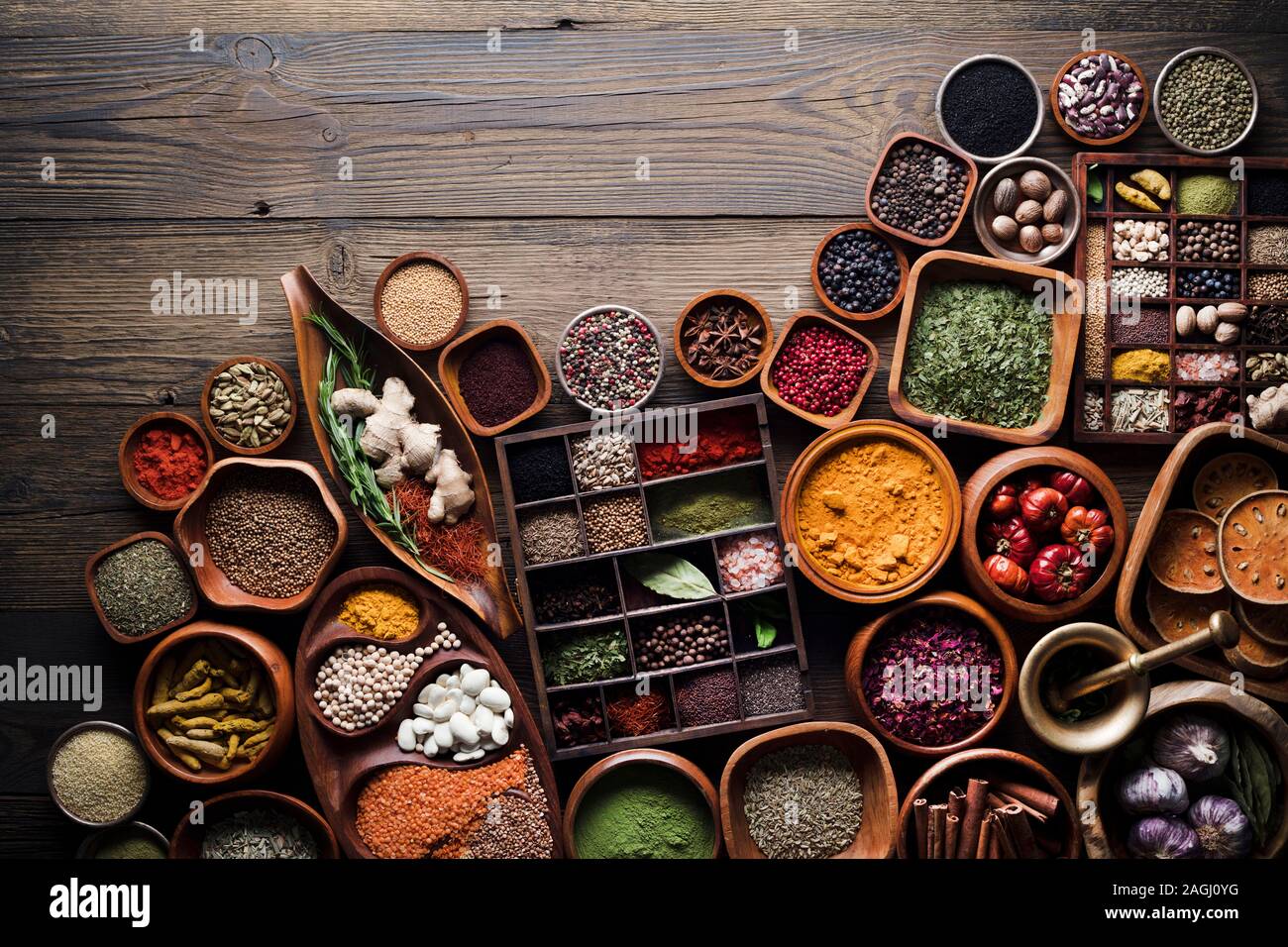 Set of colorful spices in different bowls on wooden table. Top view ...