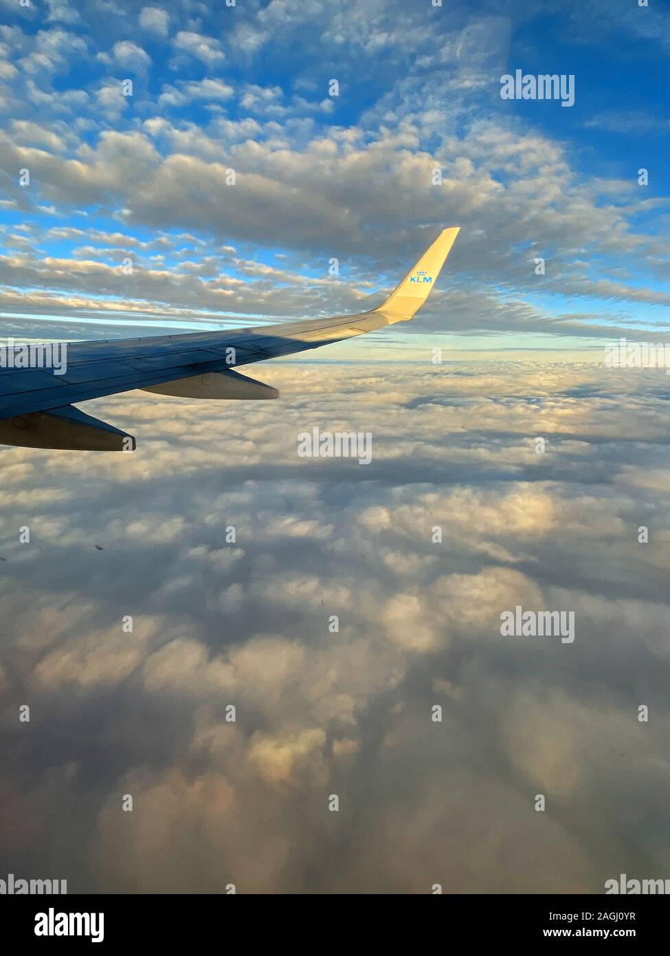 Flight over clouds from above by plane Stock Photo - Alamy