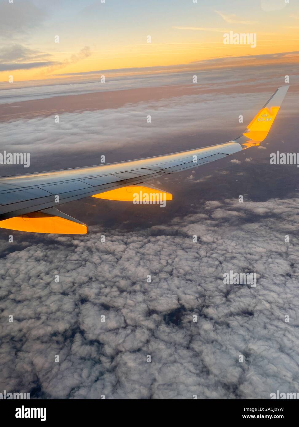 Flight over clouds from above by plane Stock Photo - Alamy