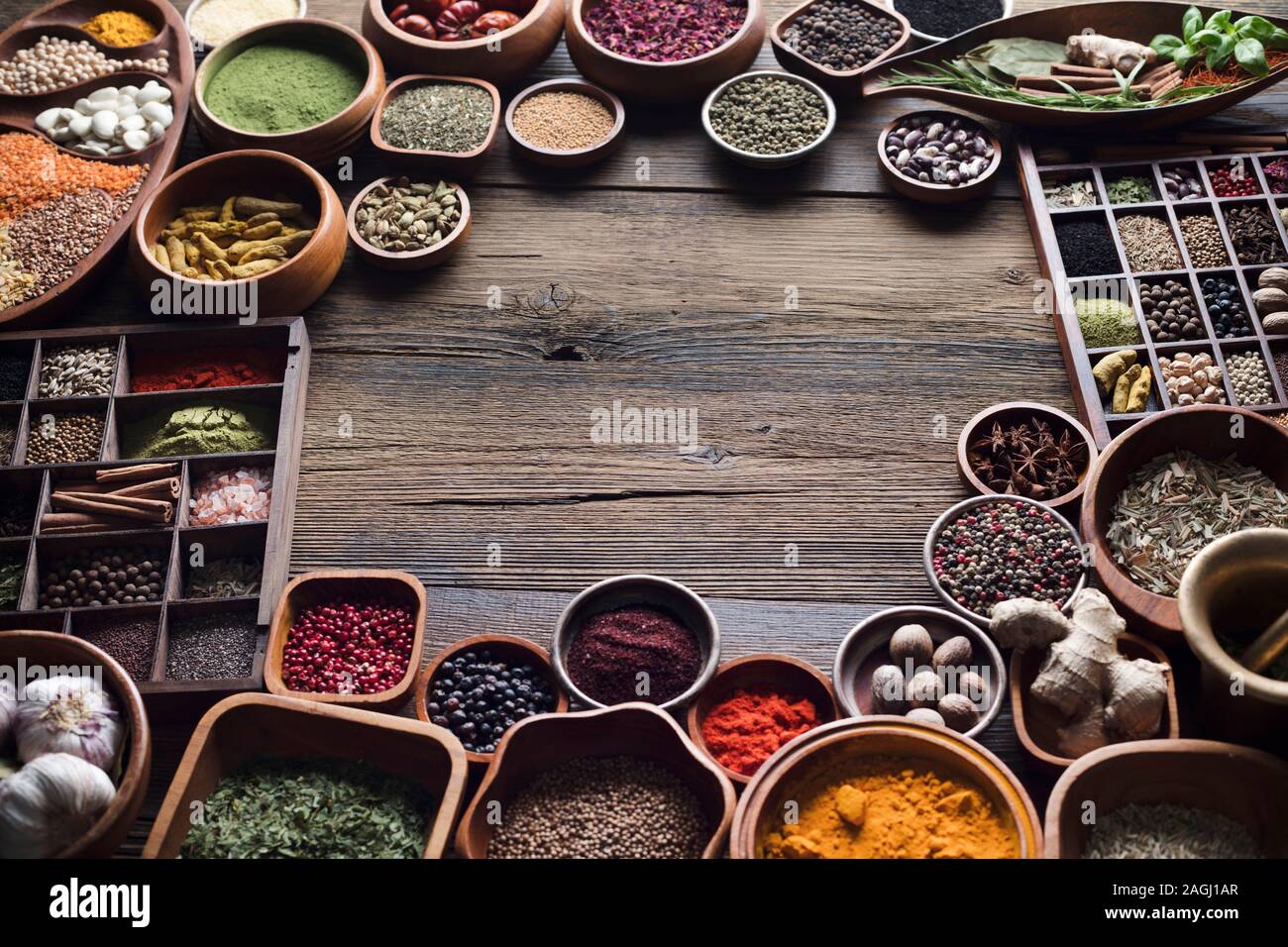 Set of colorful spices in different bowls on wooden table. Top view ...