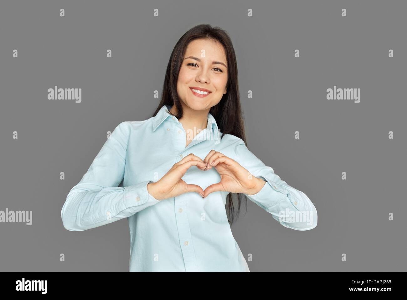 Positive asian woman showing heart hi-res stock photography and images ...