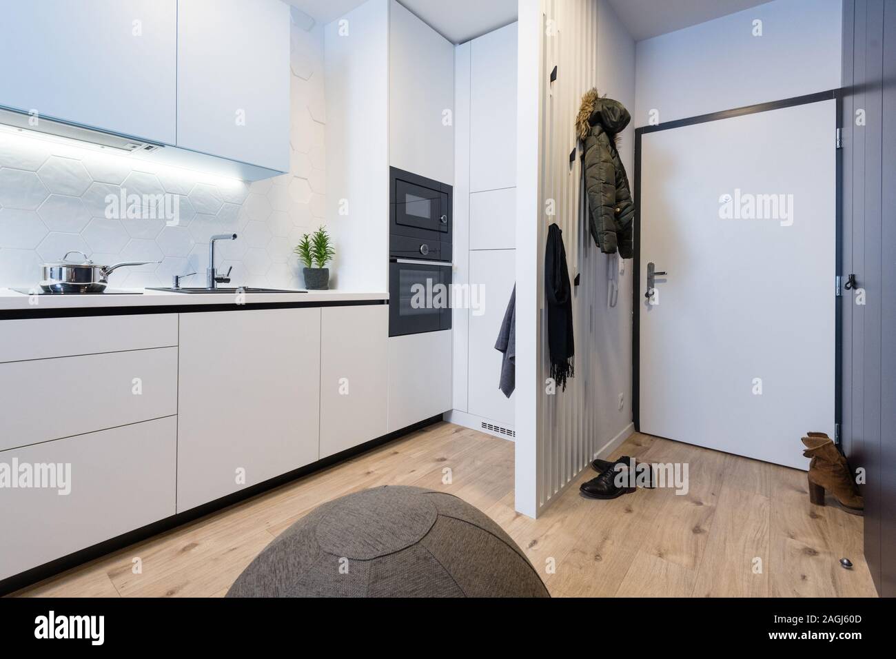 Kitchen and entrance hall of modern apartment Stock Photo - Alamy