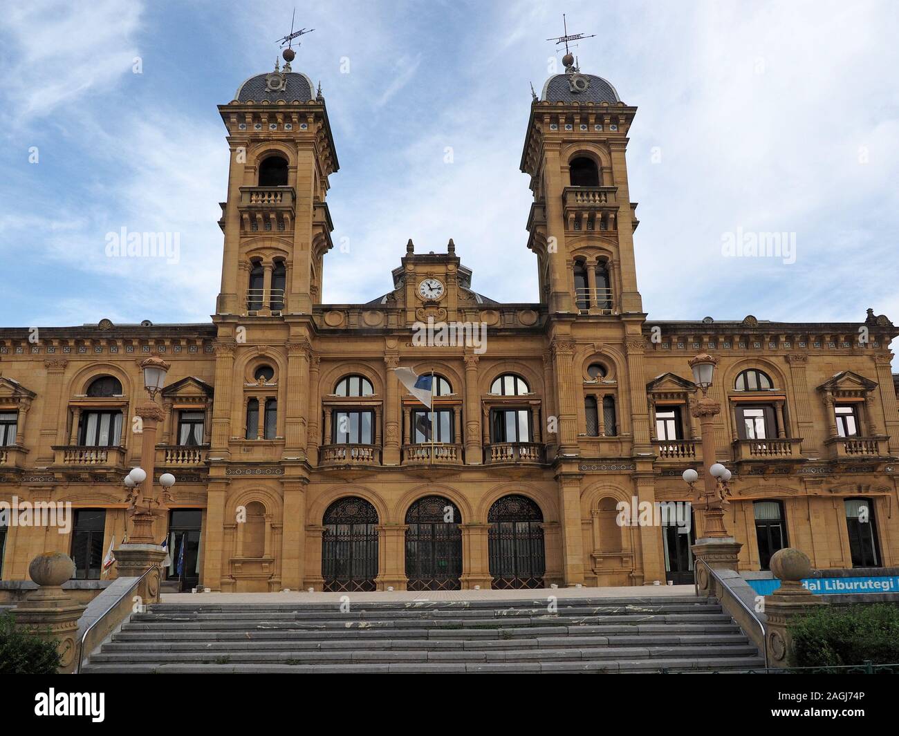 classical stone Town Hall building with weather vanes on twin towers ...