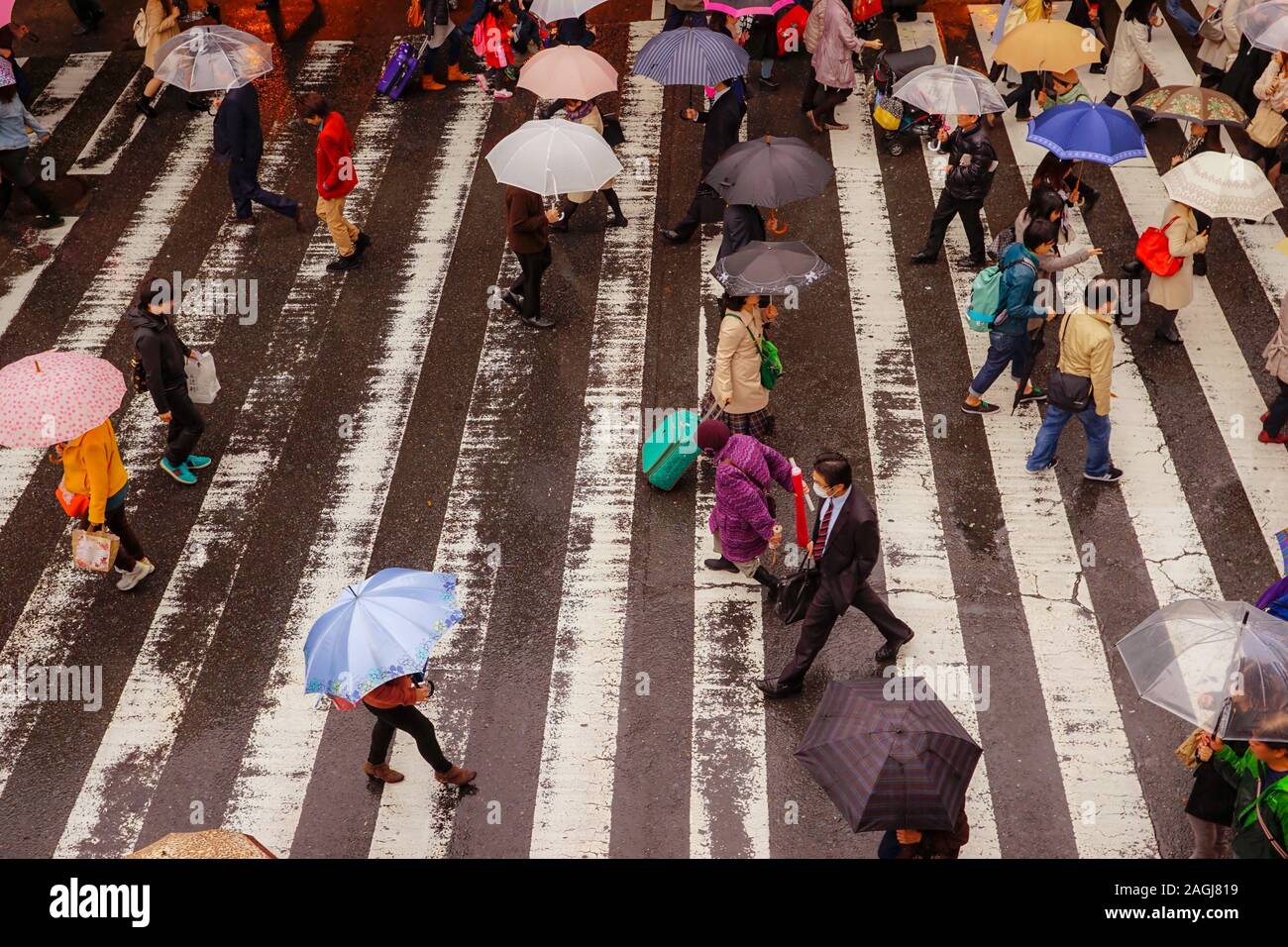 OSAKA, JAPAN - NOVEMBER 25, 2014: People walking under rain in a ...