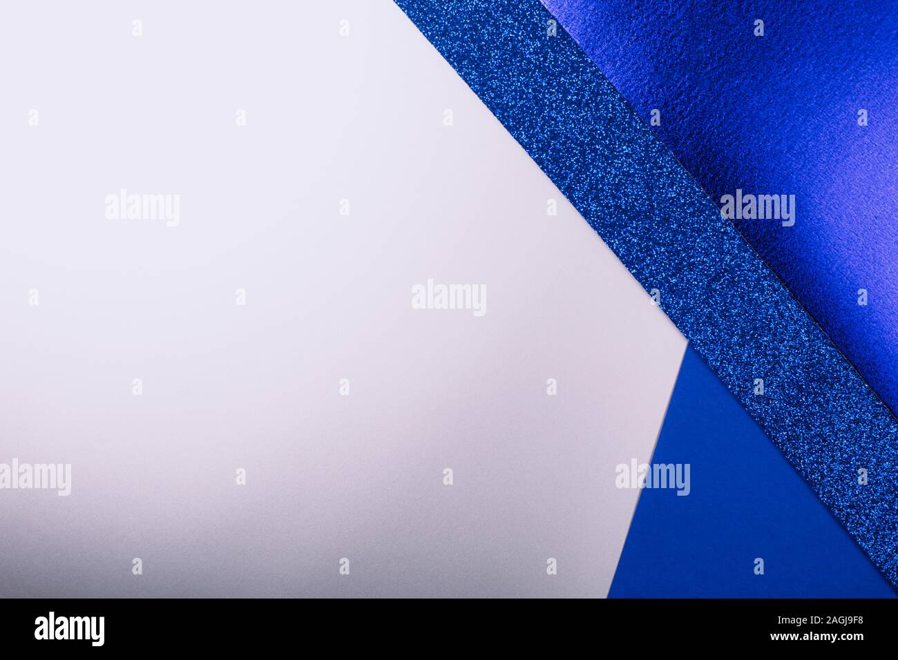 Divided in several parts blue paper background with metallic elemments ...