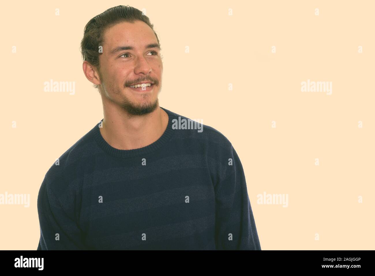 Close up of young happy man smiling while thinking isolated against ...