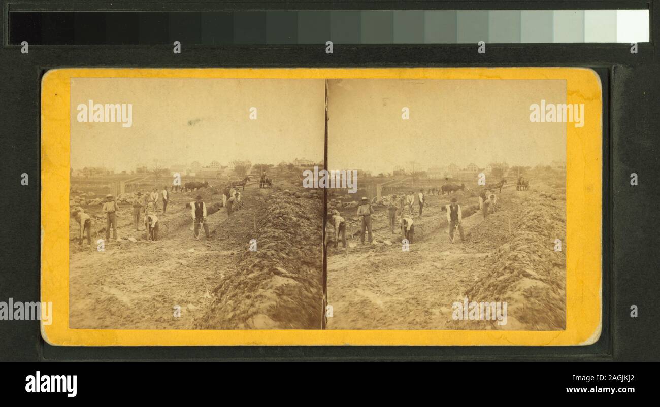 Men at work digging a wide ditch Men at work digging a wide ditch.; Men ...