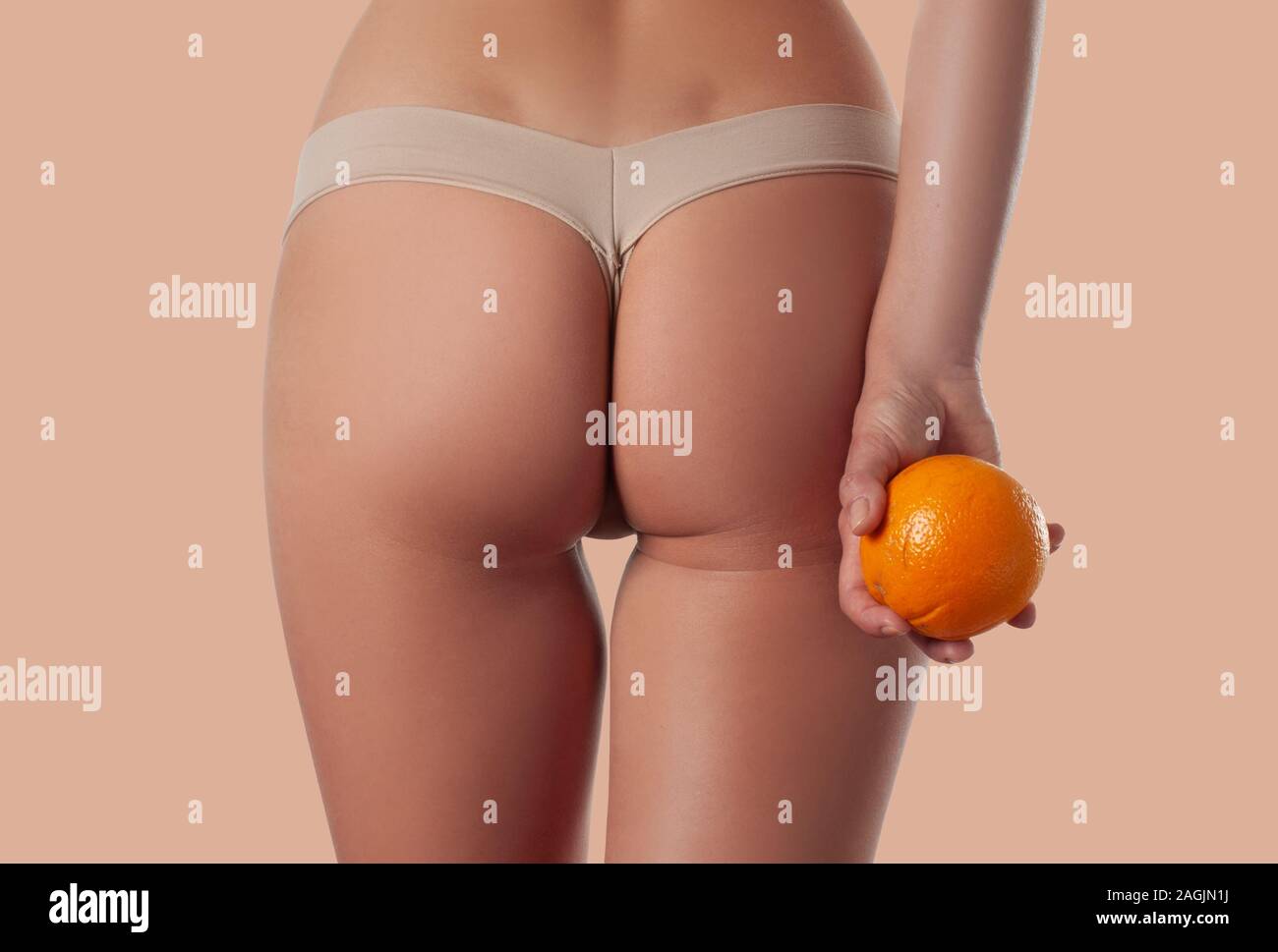 Slim woman is holding orange. Perfect female buttocks without cellulite. Beautiful woman s butt in underwear. Body care and anti cellulite massage Stock Photo Alamy