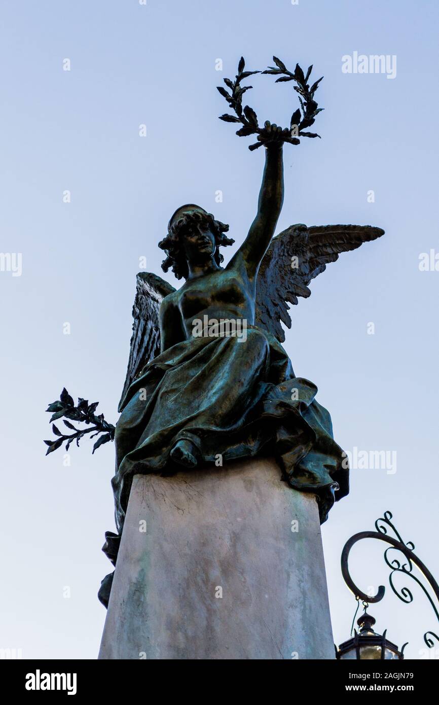 Sculpture of an angel in the sky with a laurel crown Stock Photo - Alamy