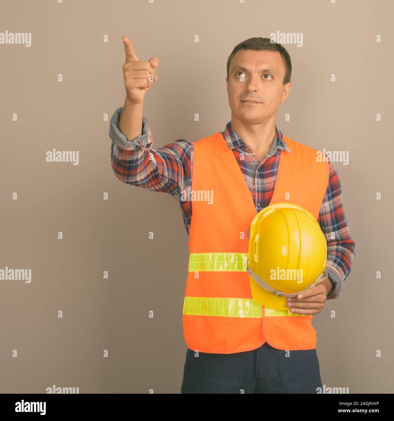 Man construction worker against gray background Stock Photo - Alamy