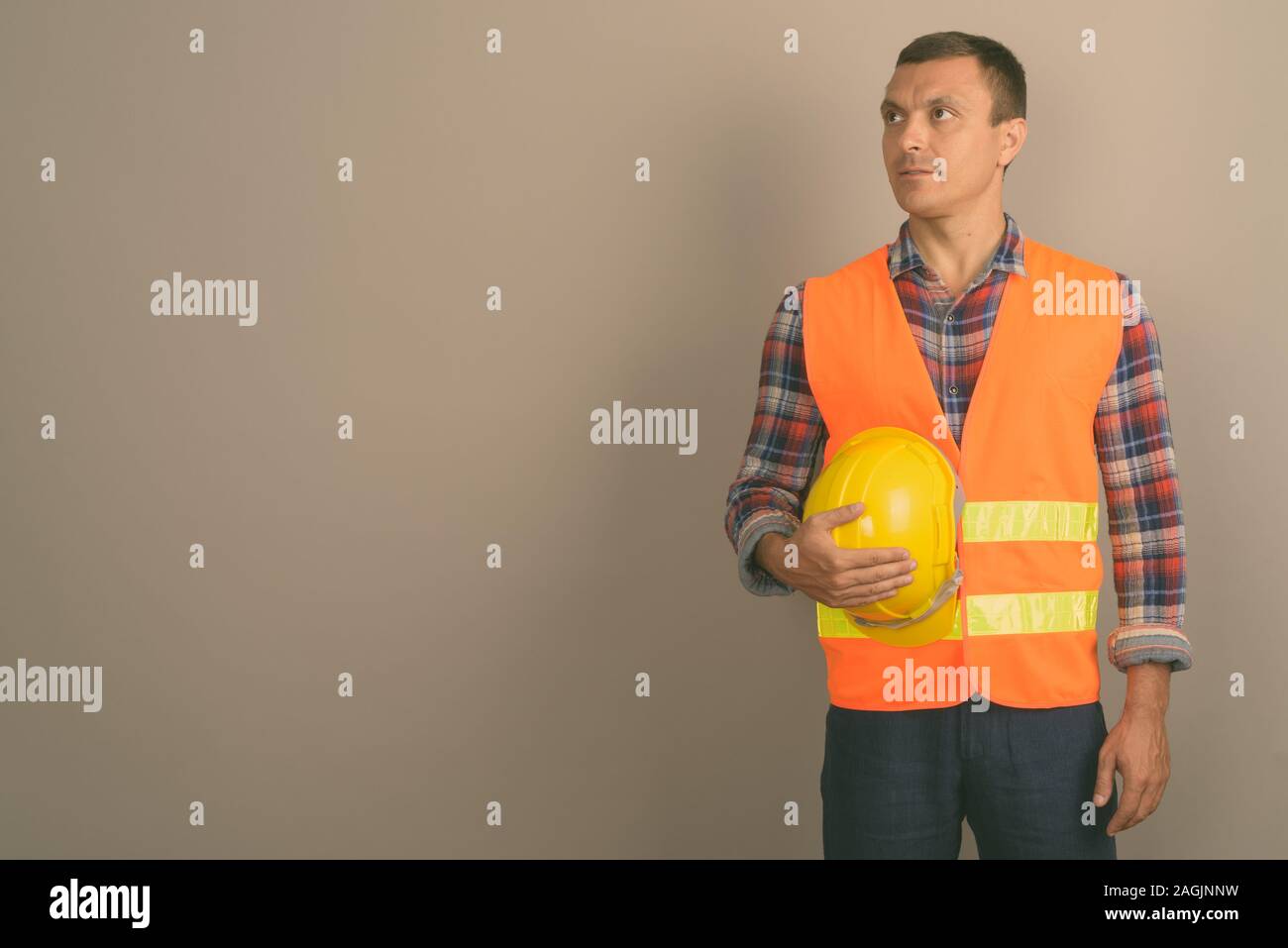 Man construction worker against gray background Stock Photo - Alamy