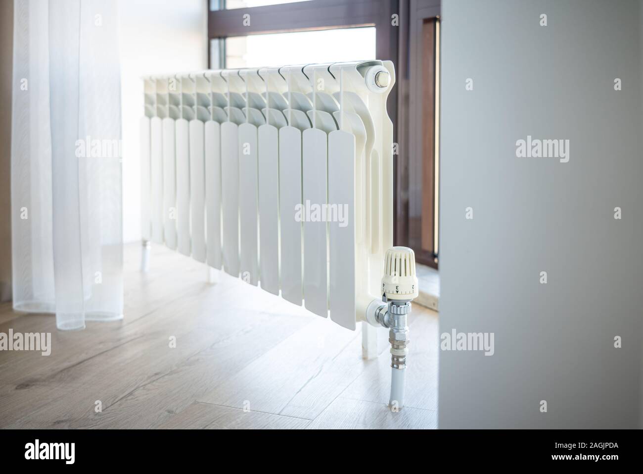 White big radiator near window in a modern room Stock Photo - Alamy