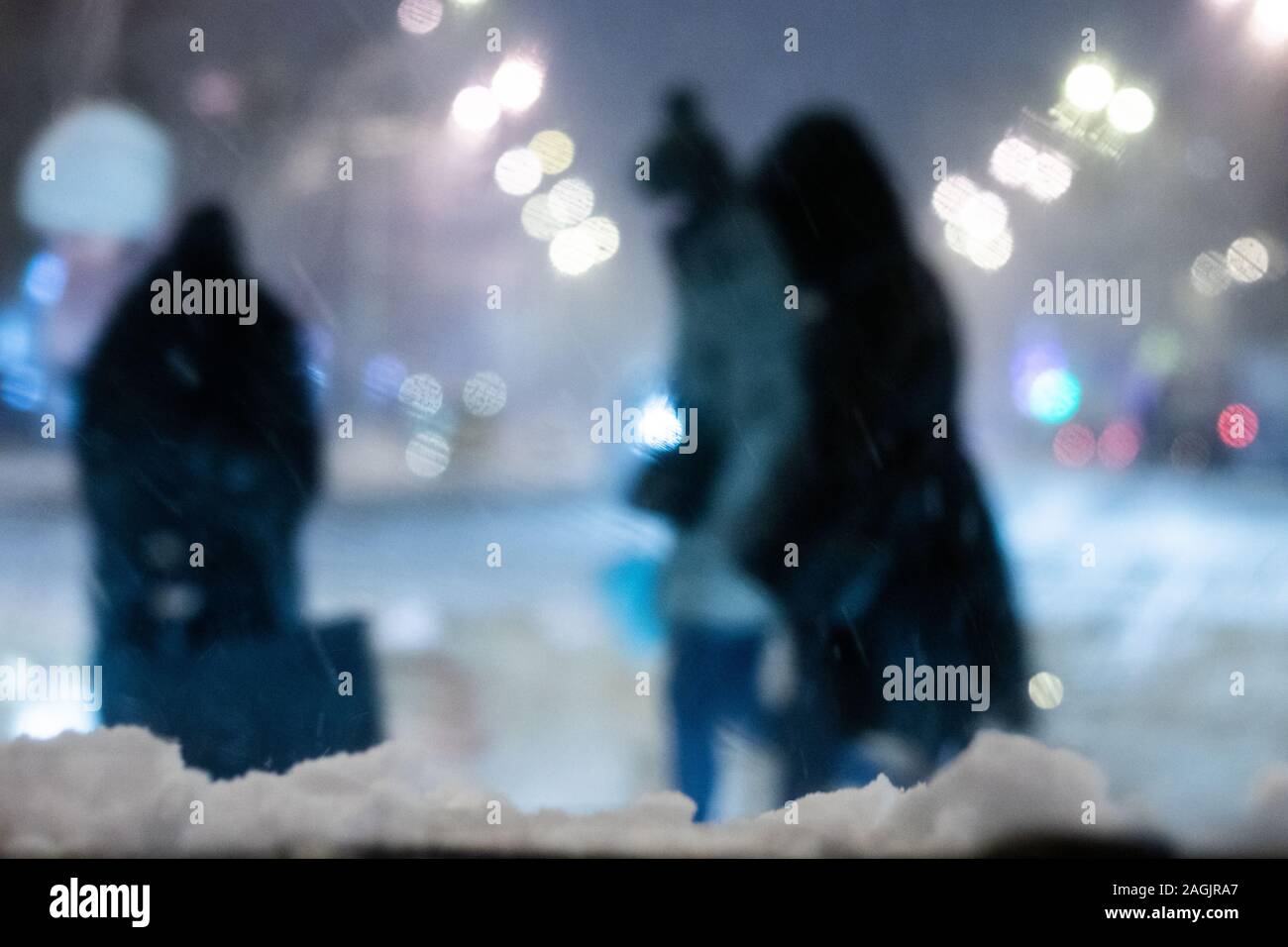Defocused photo of snow storm excessive precipitation on Winter street ...