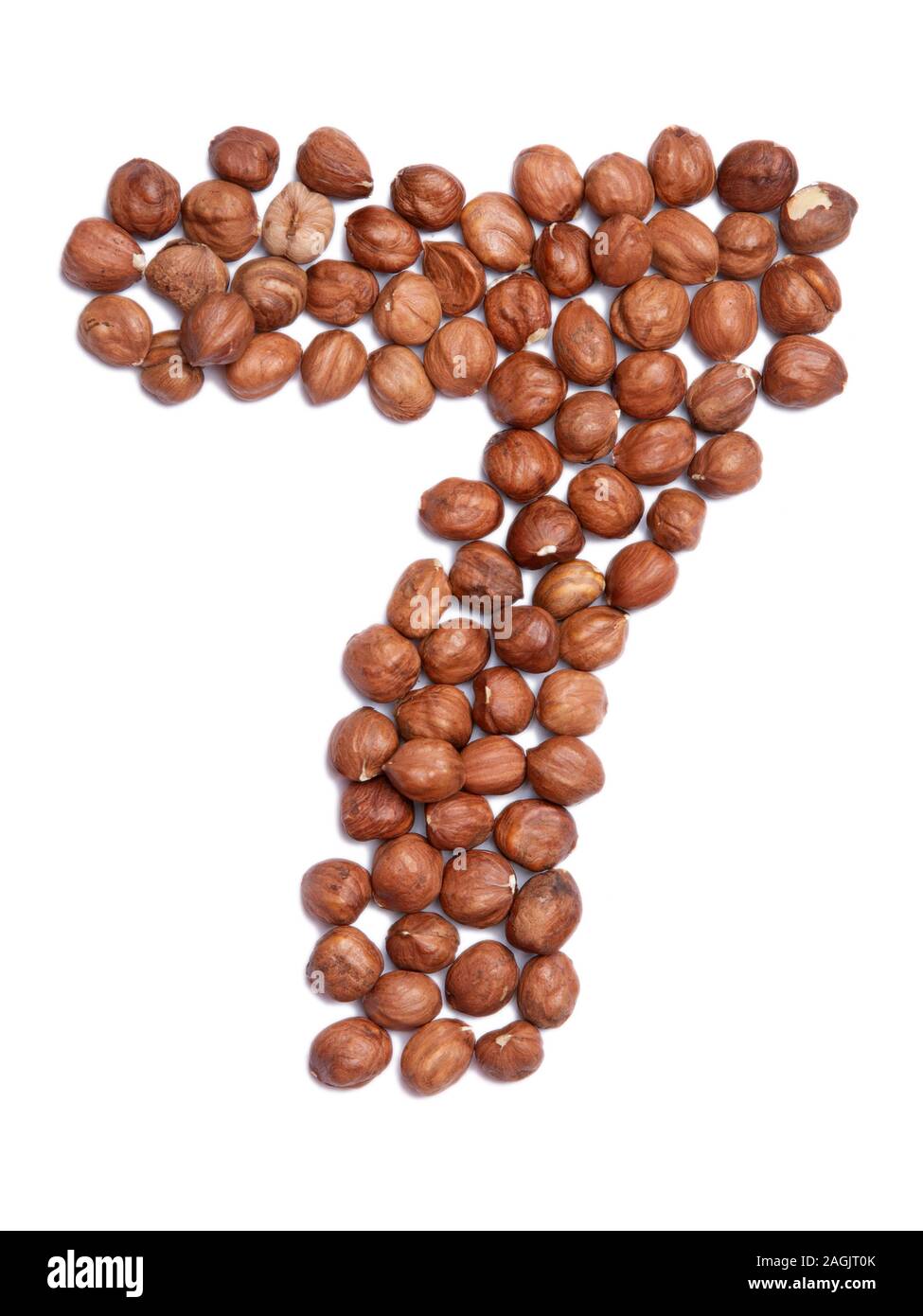 Arabic numeral "7" from peeled hazelnut on a white isolated background ...