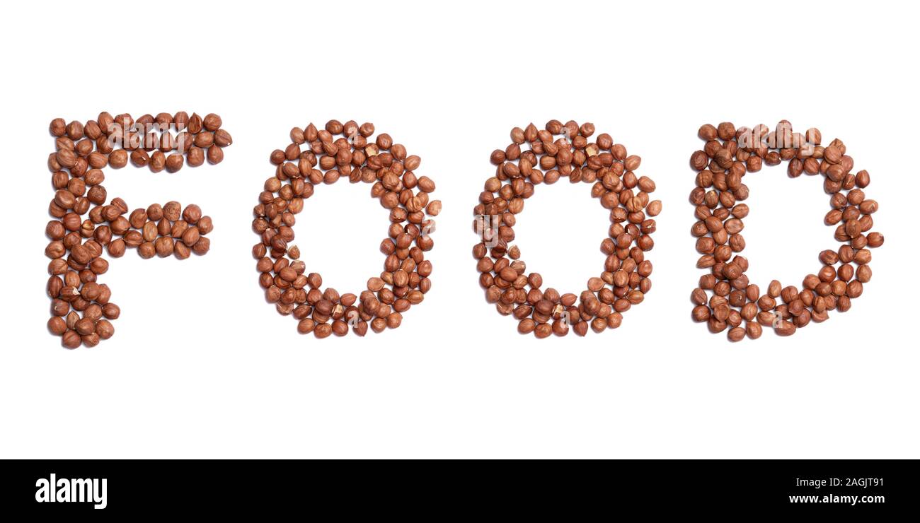 Inscription "Food" of the English alphabet from a peeled hazelnuts on a ...