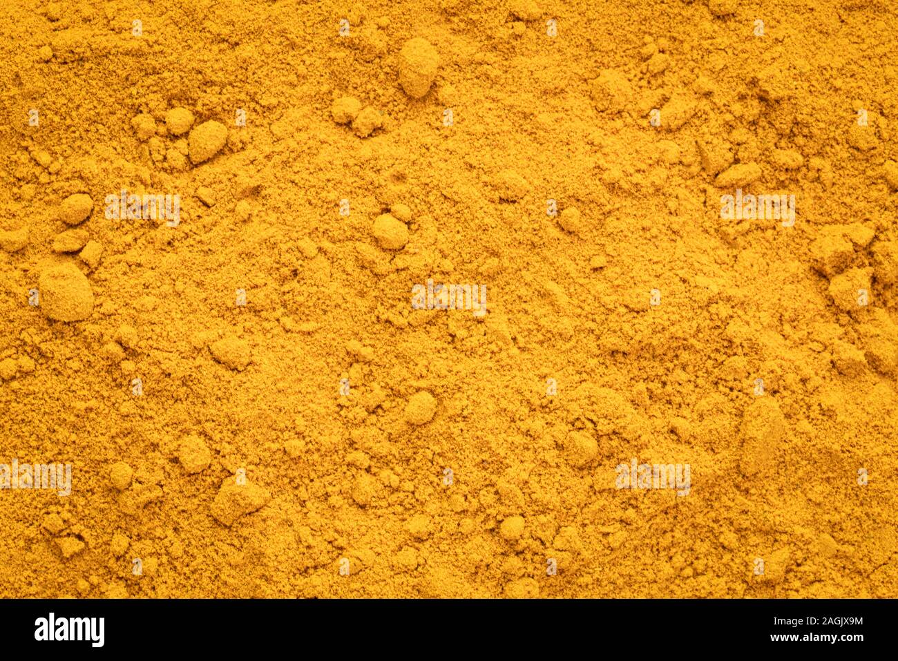 Turmeric root powder background and texture Stock Photo - Alamy