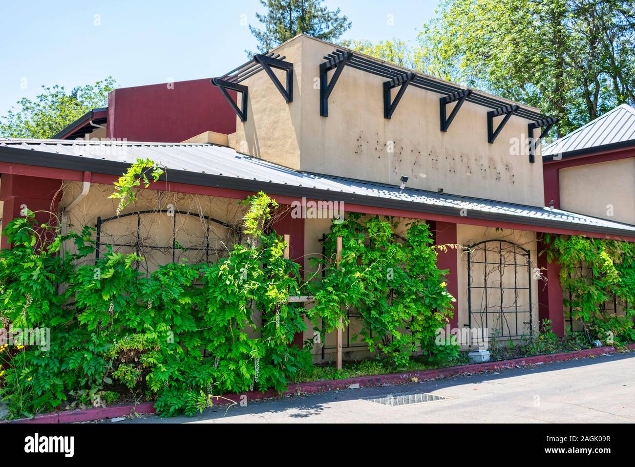 Abandoned building facade with removed property signature and overgrown ...