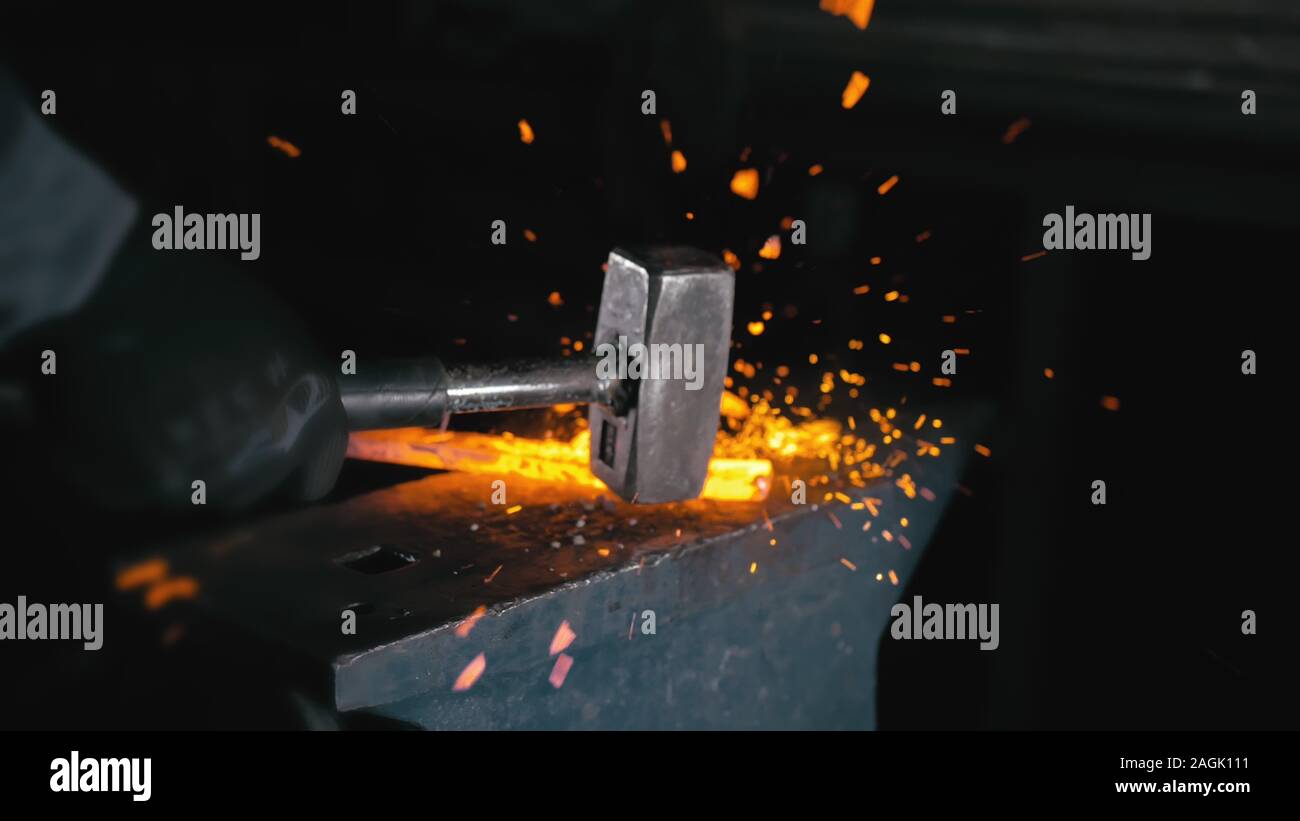 Forge workshop. Smithy manual production. Hands of smith with hammer ...