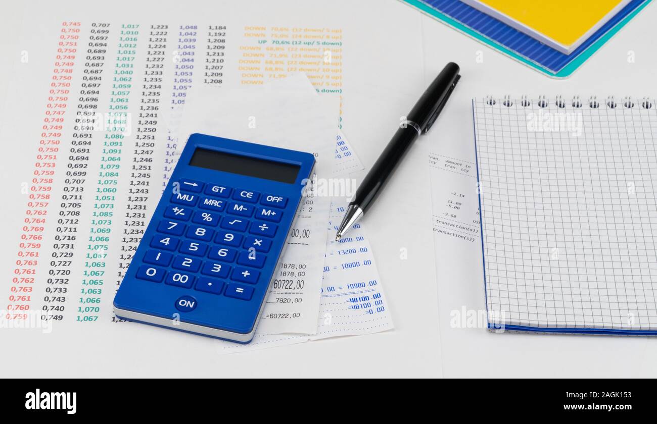 Calculator and notepad on top of supermarket receipt. Shopping and ...