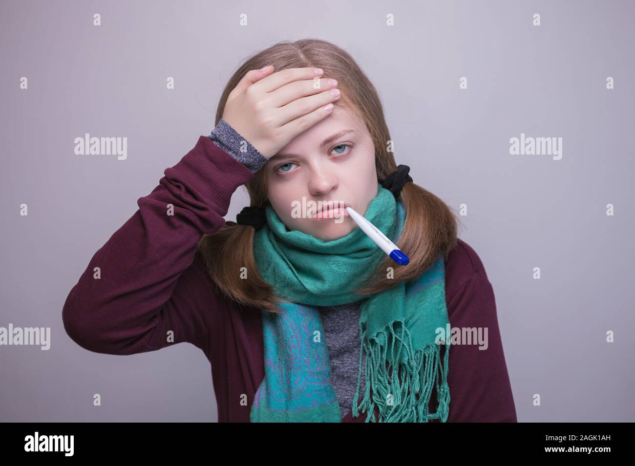 Young caucasian girl woman with thermometer looks sick, fever, cold ...