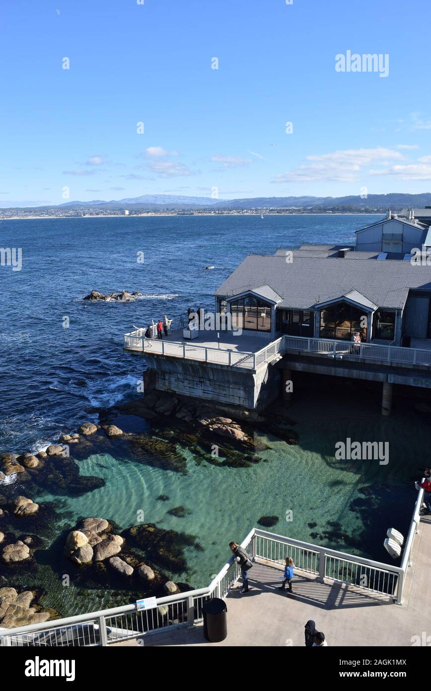 A small tide pool within Monterey Bay Aquarium looking out to the city ...