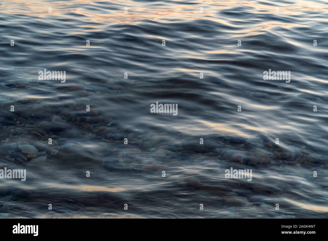 Sea waves reflecting amazing colors from the sky during sunset Stock ...