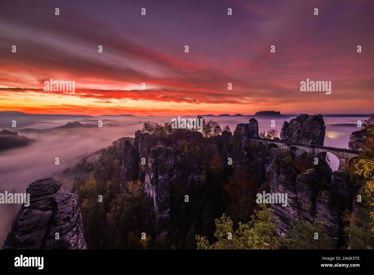 Colorful sunrise over Neurathen Castle and Bastei bridge in the ...
