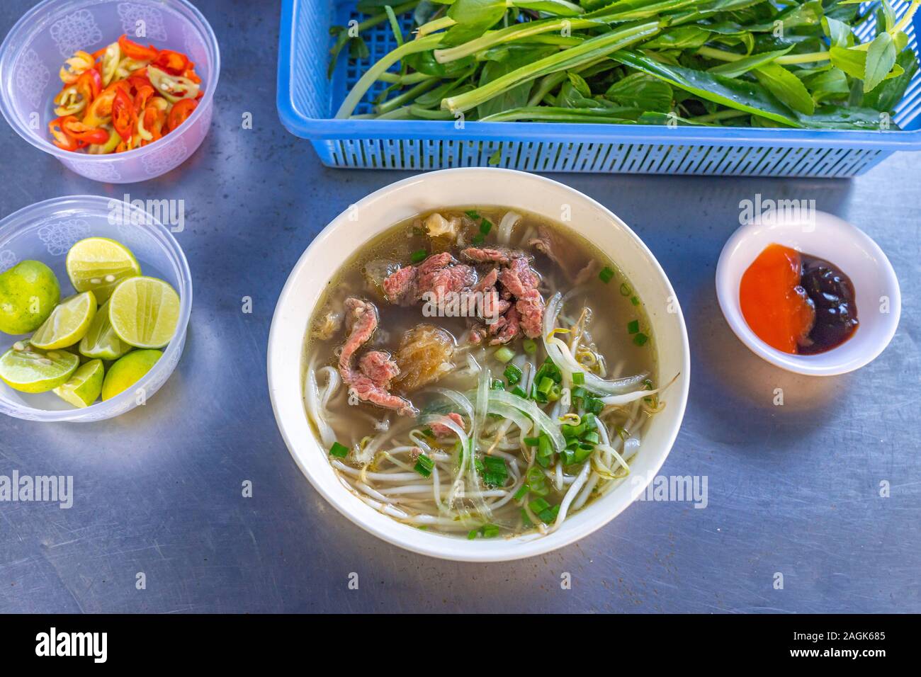Vietnamese Pho noodle soup served with vegetables and bean sprouts ...