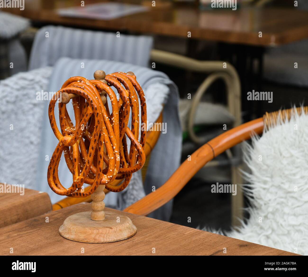 Traditional pretzels called Brezel hang on the stand on the table Stock ...