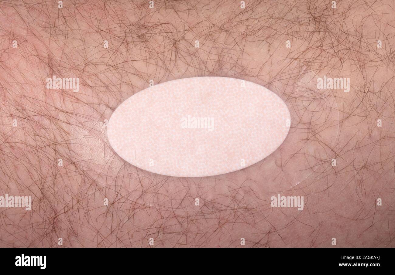 Band aid on skin, hairy leg, adult Stock Photo - Alamy