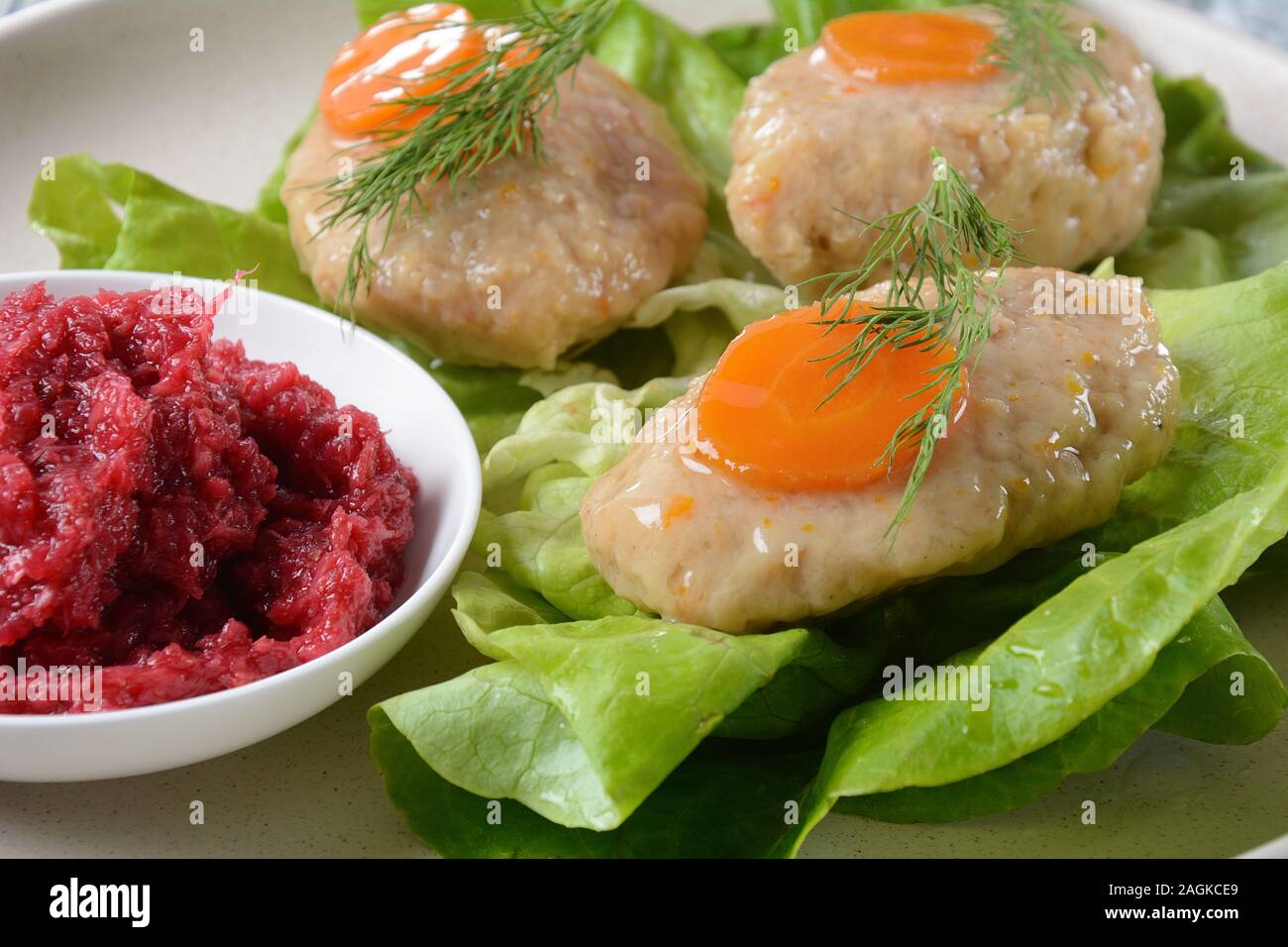 Traditional Jewish Passover food- gefilte fish with carrots, lettuce ...