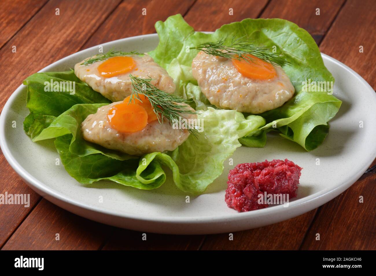 Traditional Jewish Passover food- gefilte fish with carrots, lettuce ...