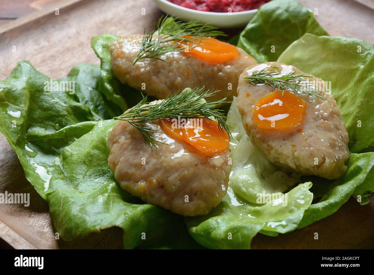 Traditional Jewish Passover food- gefilte fish with carrots, lettuce ...