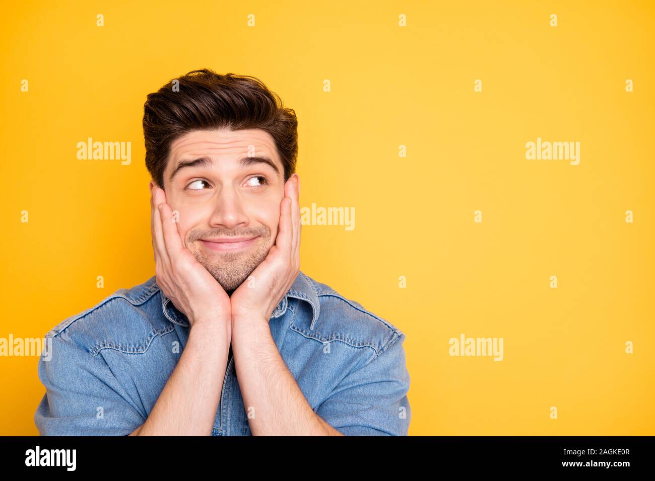 Photo of cheerful cute attractive man looking into empty space waiting ...