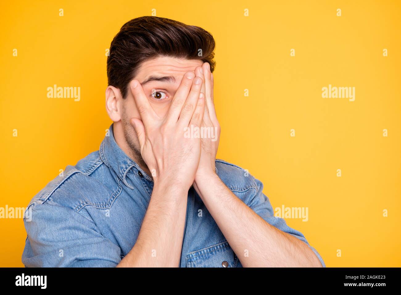 Hiding face behind fingers hi-res stock photography and images - Alamy