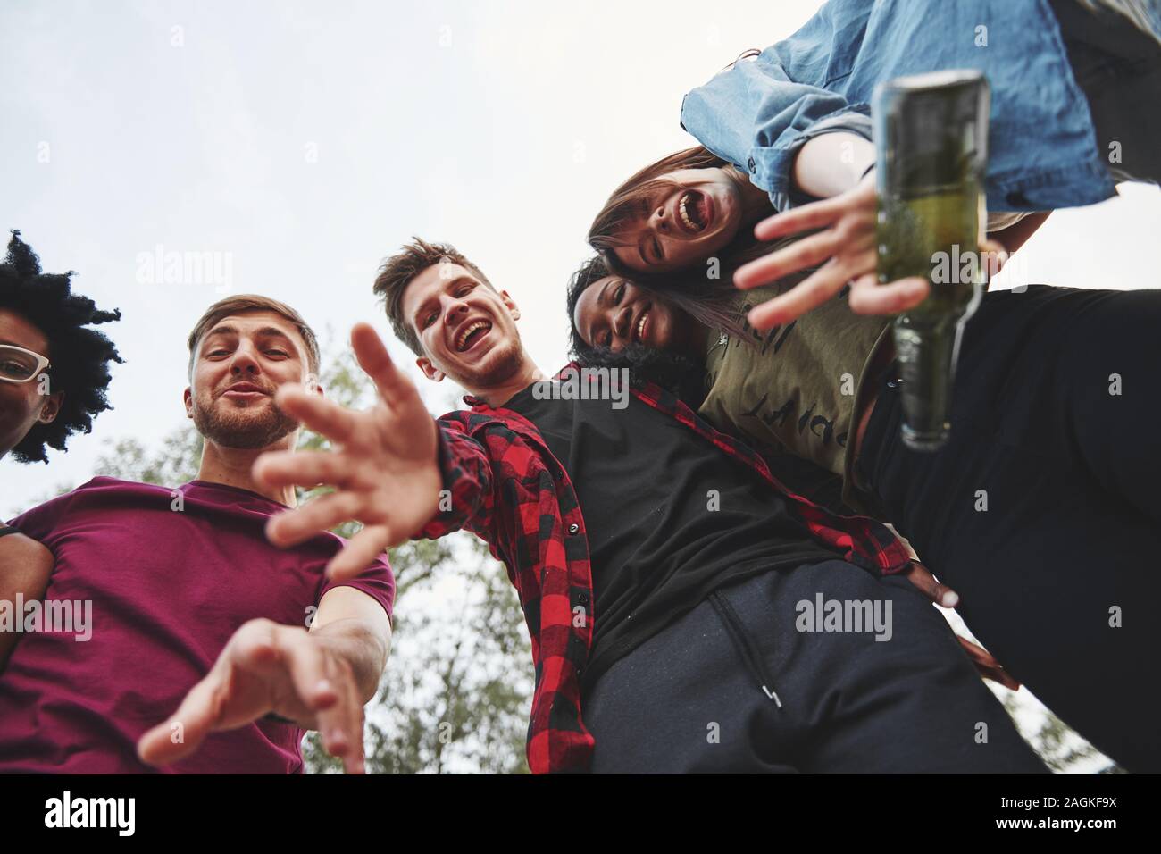 Hello there. Multi ethnic group of people have party outdoors. View ...