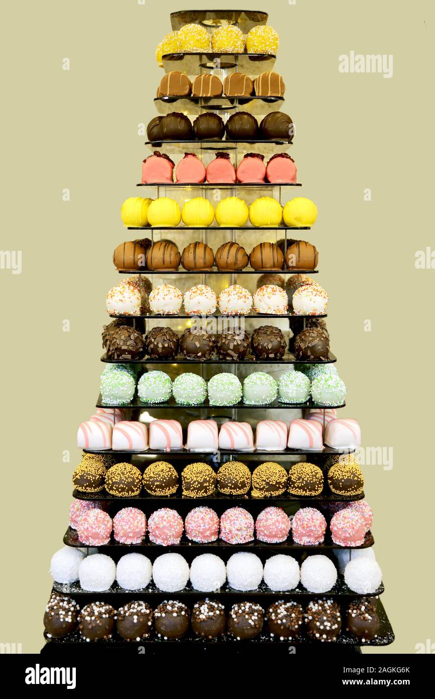 Tower or pyramid and cupcakes on sweet dessert table. Sweets in various ...