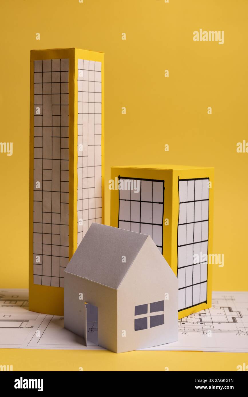 Yellow paper block of flats on yellow background paper. Minimalistic ...
