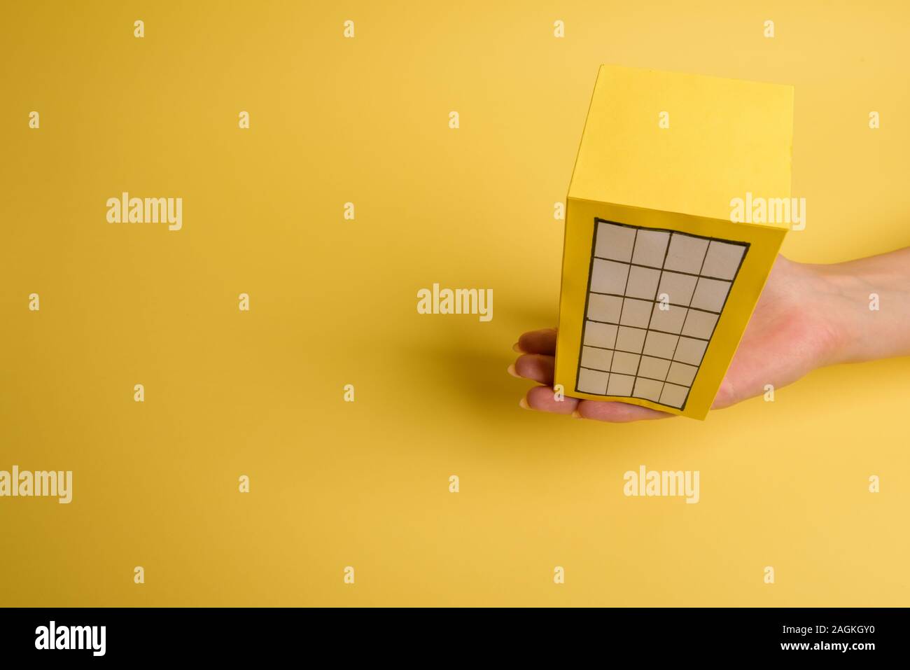 Yellow paper block of flats on yellow background paper. Minimalistic ...