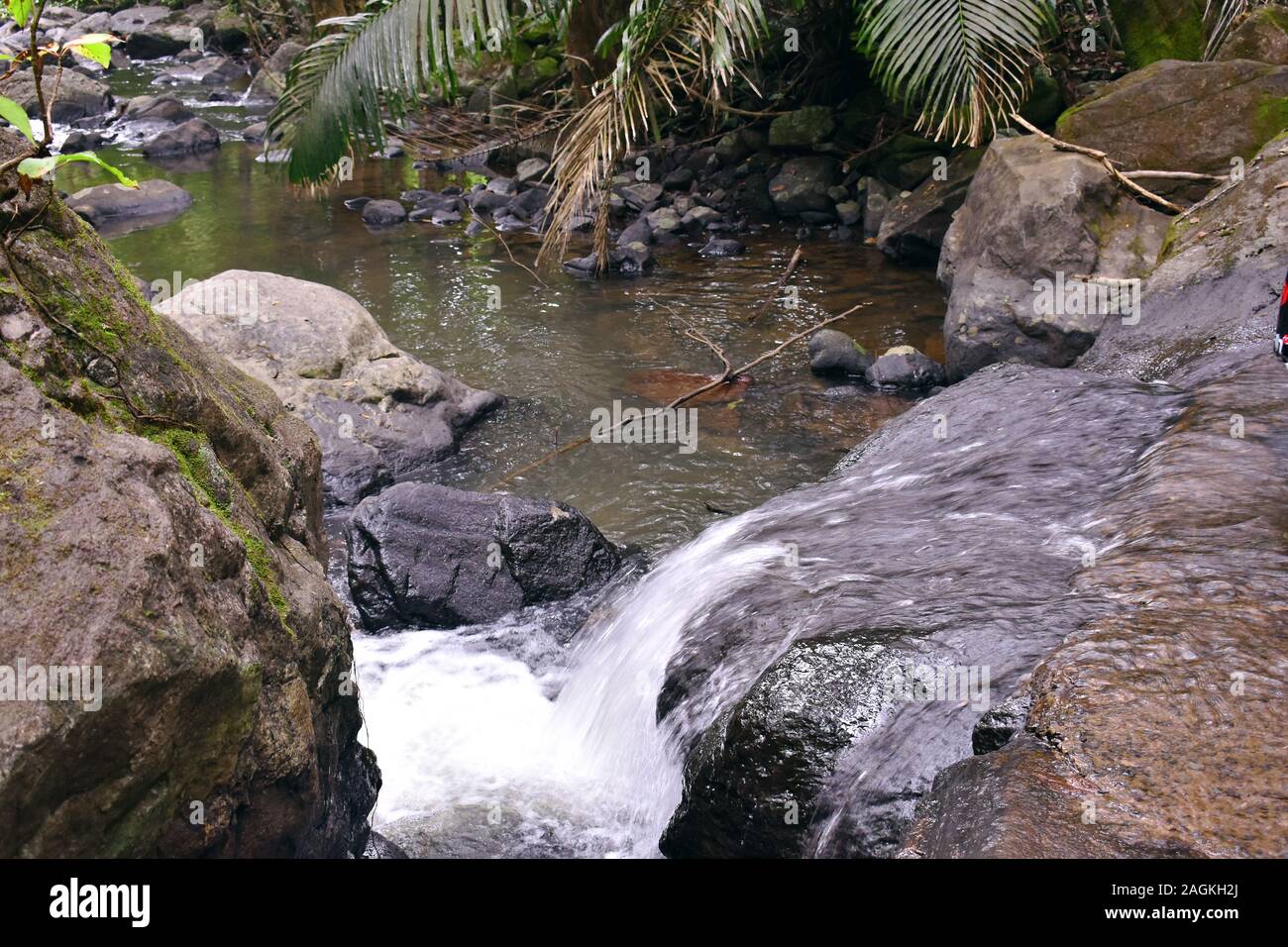 water flowing down the rock in a river Stock Photo - Alamy