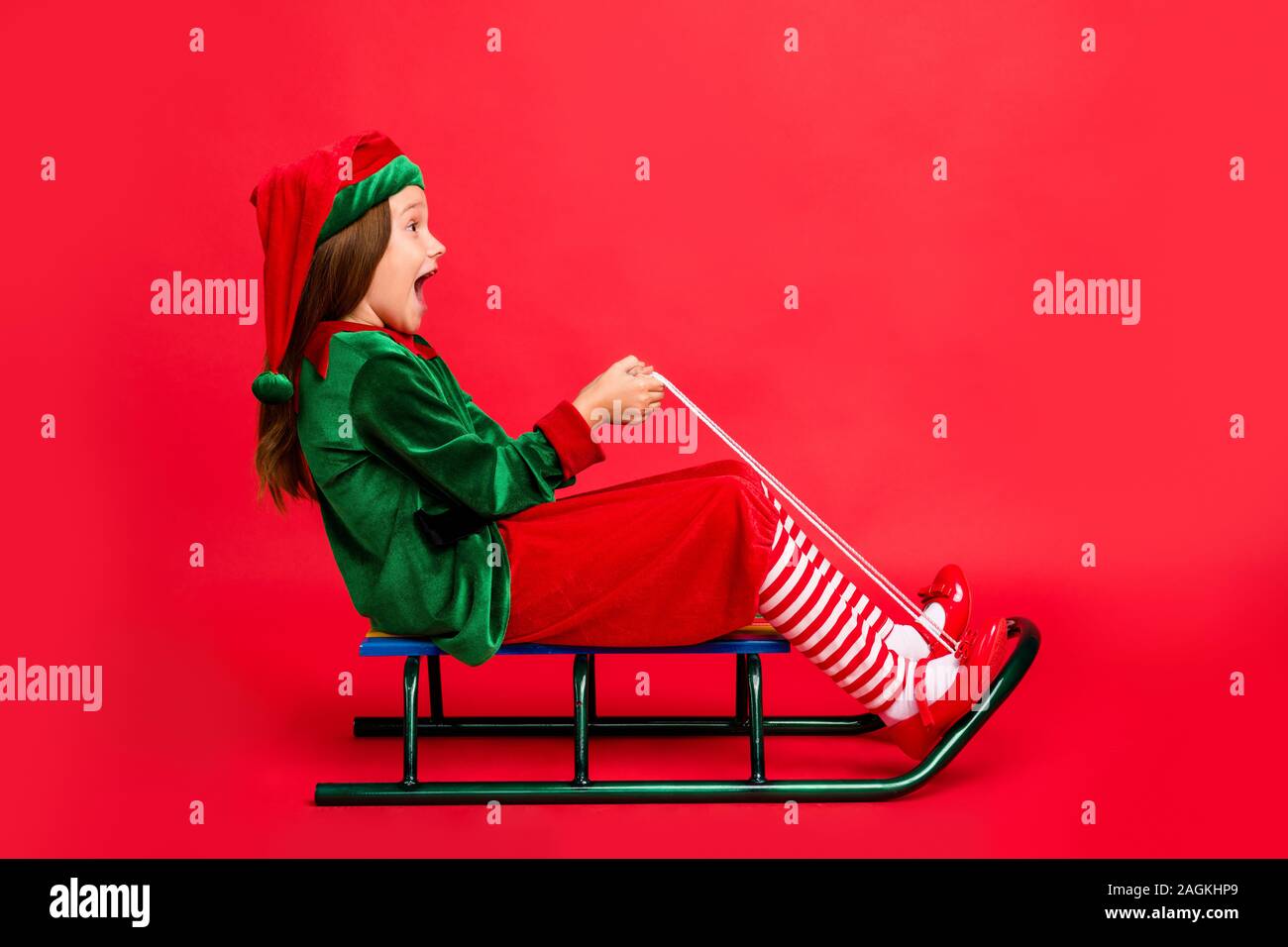Full length profile side photo of excited elf kid in hat with long red ...