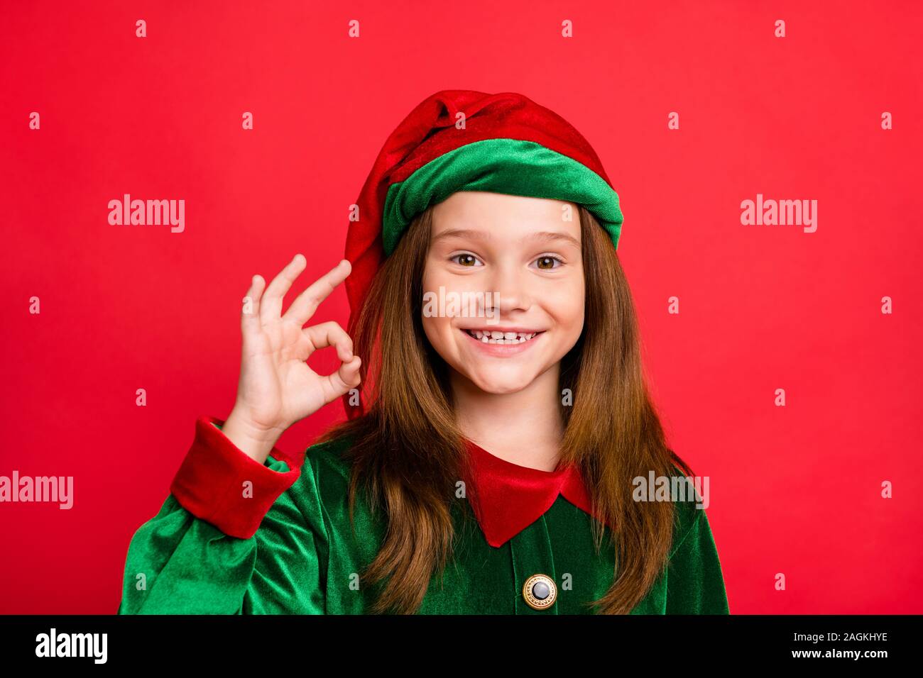 Close up photo of charming elf kid in green hat with long red head ...