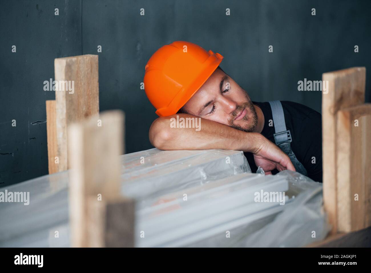 Sleeping on a job. Taking a break. Industrial worker indoors in factory ...